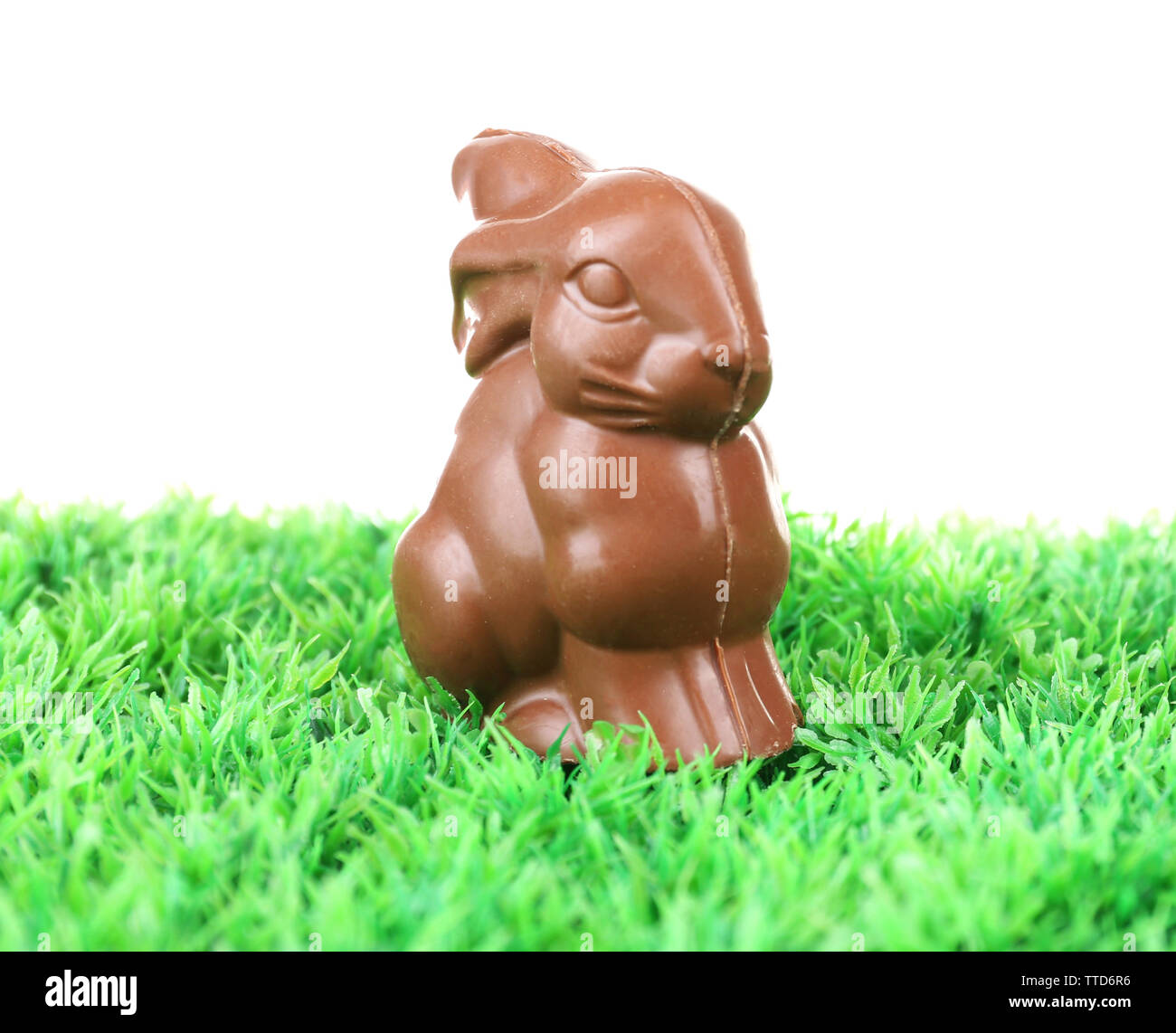 Chocolate Easter bunny on green grass, on white background Stock Photo ...