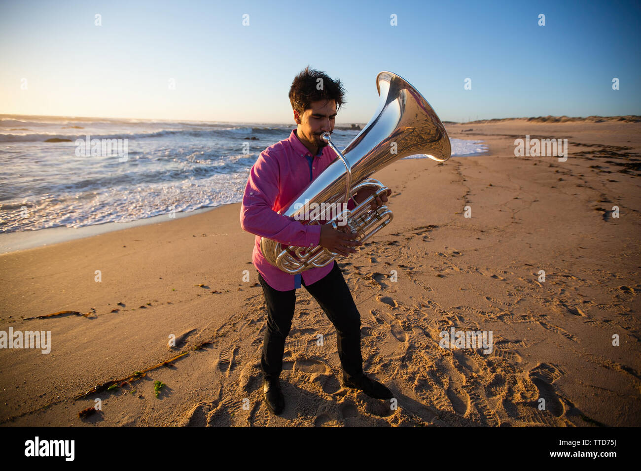 Musician with a tuba playing on the sea beach Stock Photo - Alamy