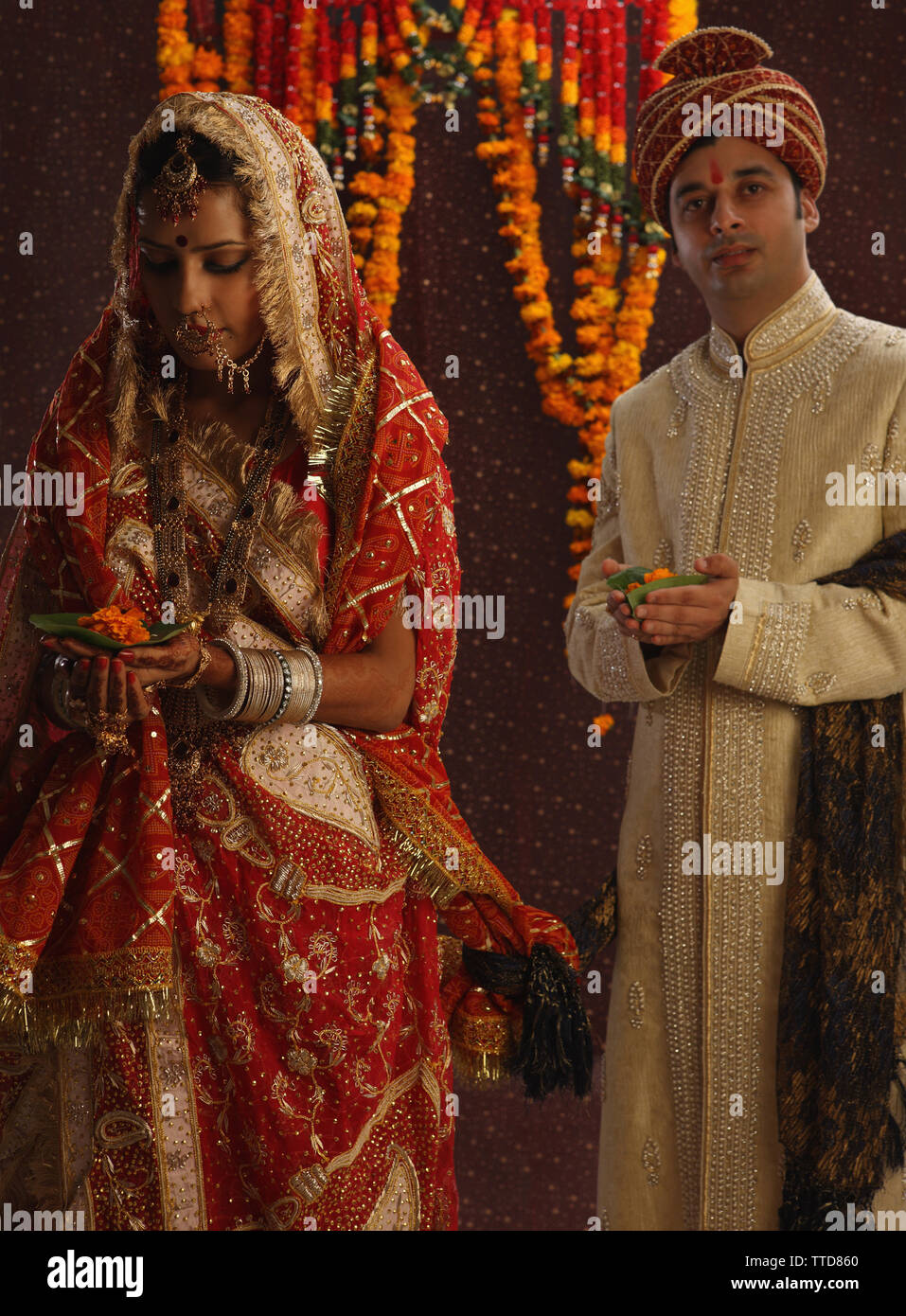 Newlywed couple performing traditional ritual Stock Photo - Alamy