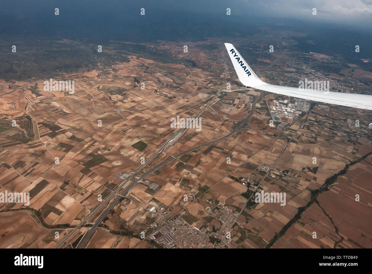 view showing the wing tip of a ryanair passenger Boeing 737 jet flying ...