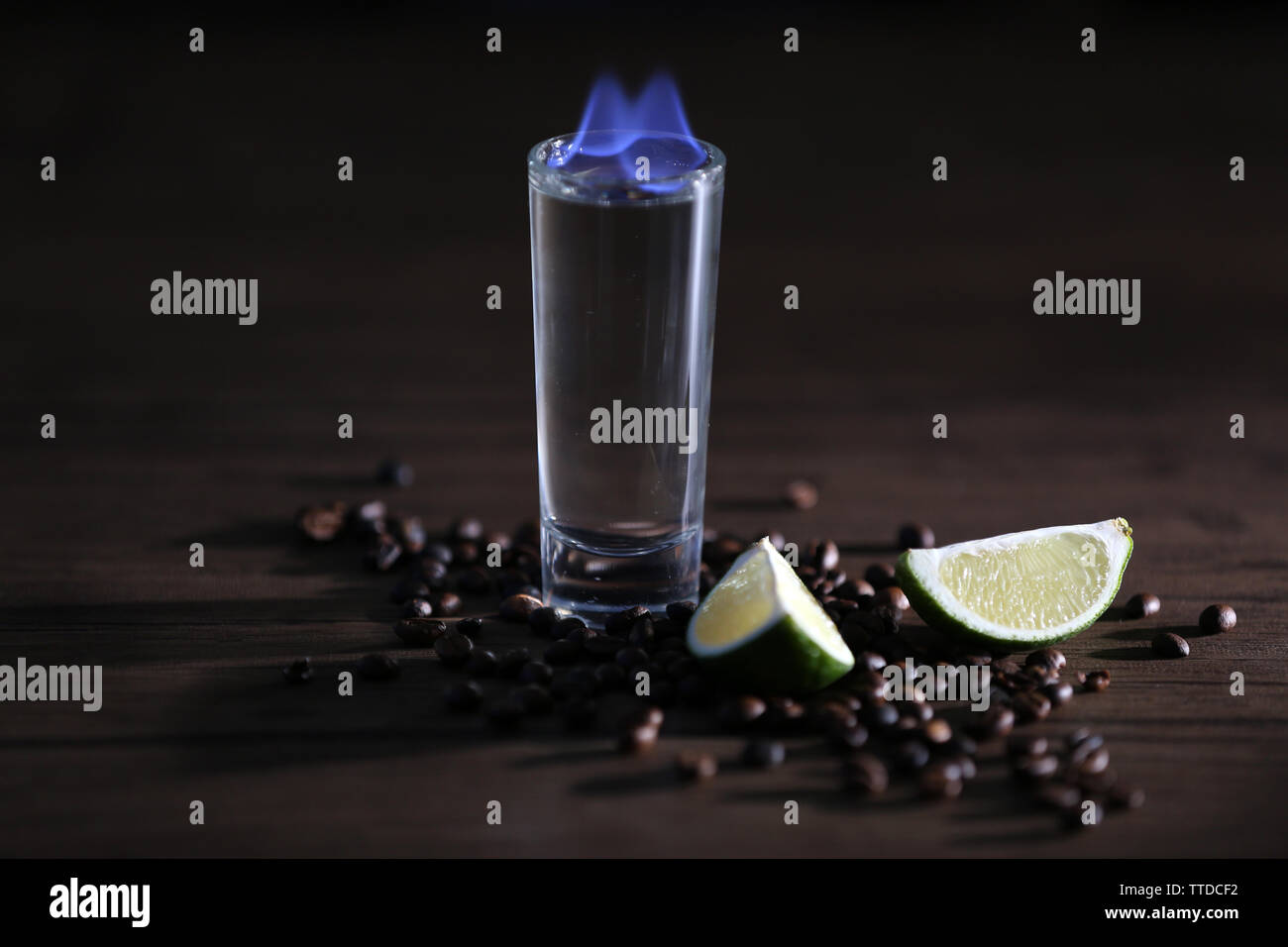 Burning cocktail with lime and coffee beans on wooden background Stock ...