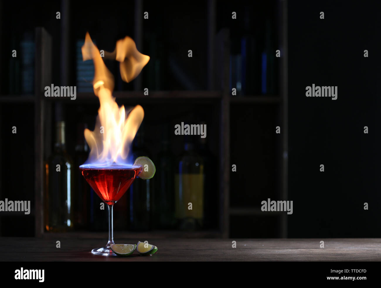 Burning cocktail and lime on table in a bar Stock Photo - Alamy