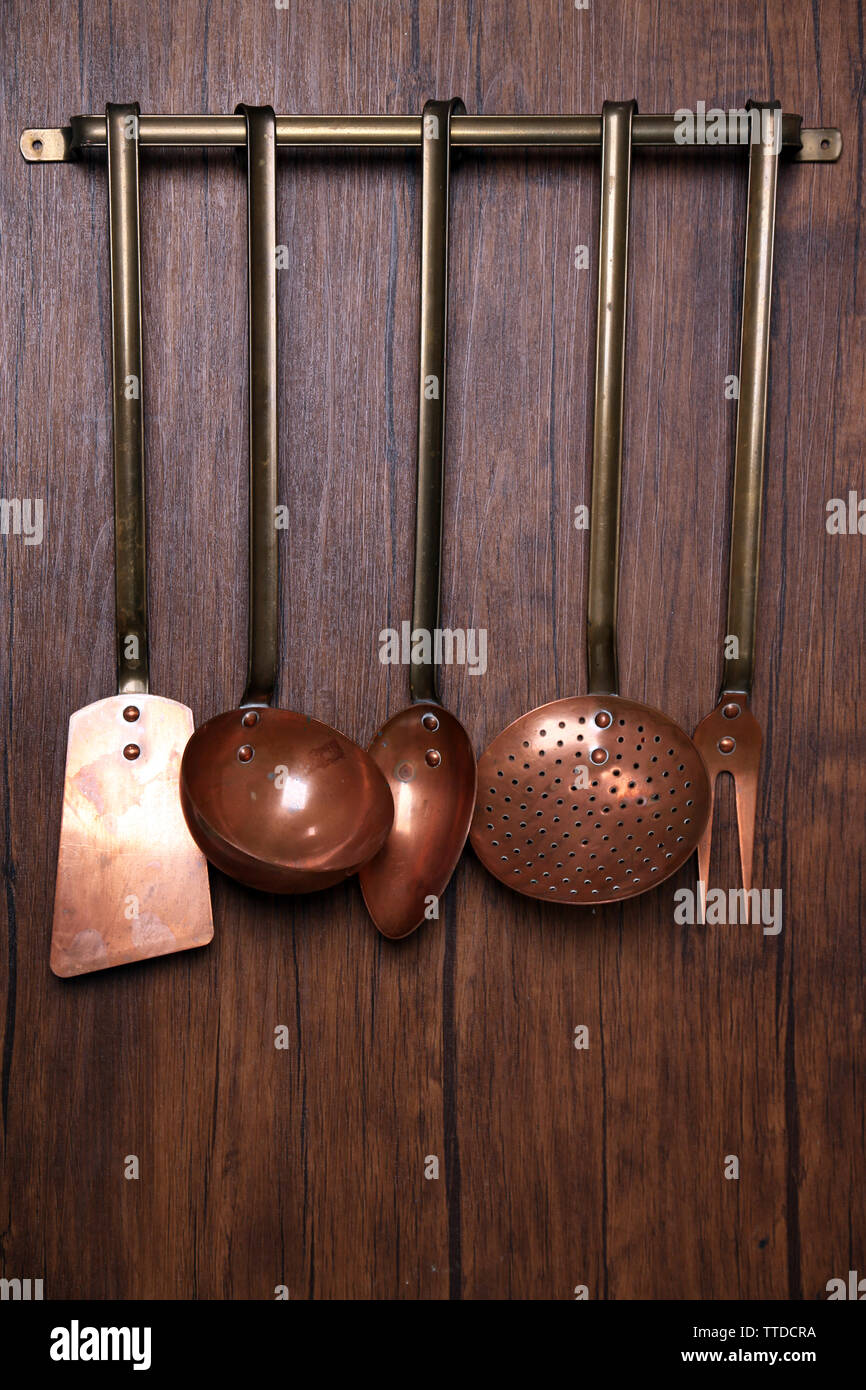 Kitchen utensil of scapula, spoons and fork on wooden background Stock ...