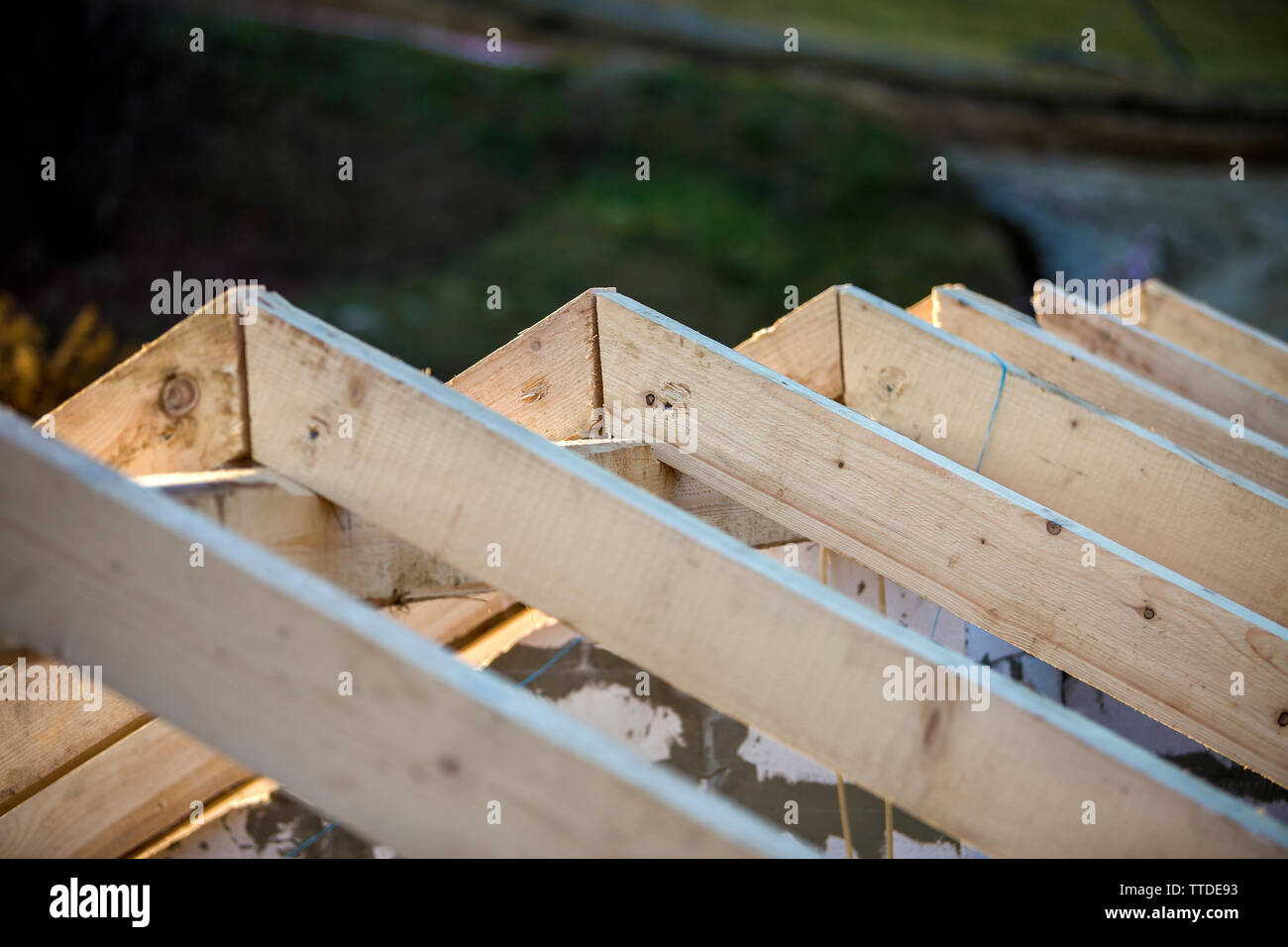 Close-up detail of roof frame of rough wooden lumber beams on ...