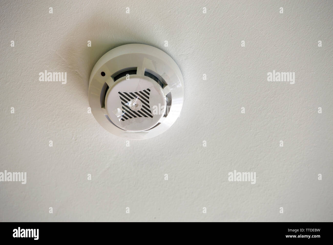 Smoke detector of fire alarm device on copy space background of white ...