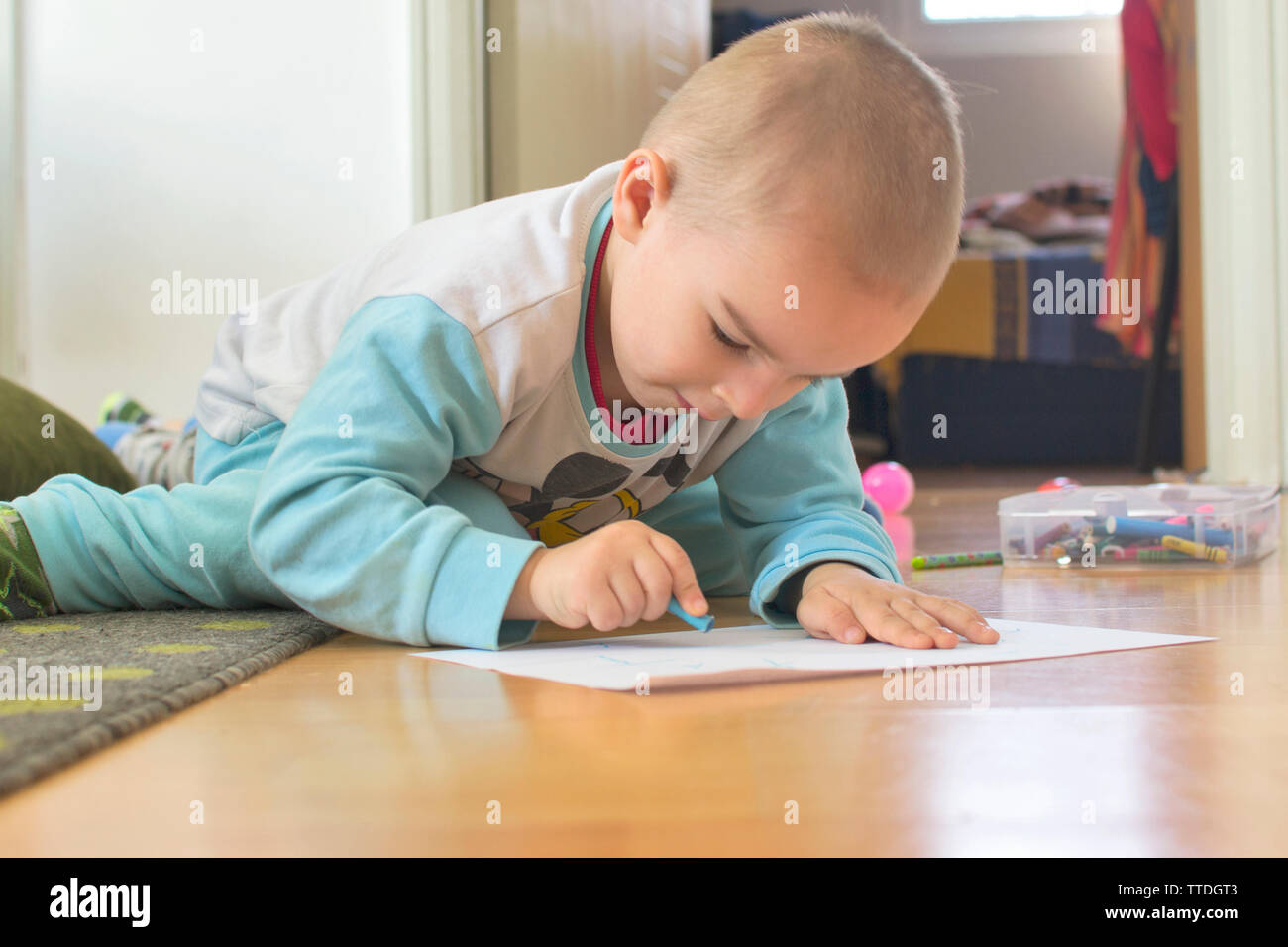 Beautiful boy writing and drawing with pencils at home Stock Photo - Alamy