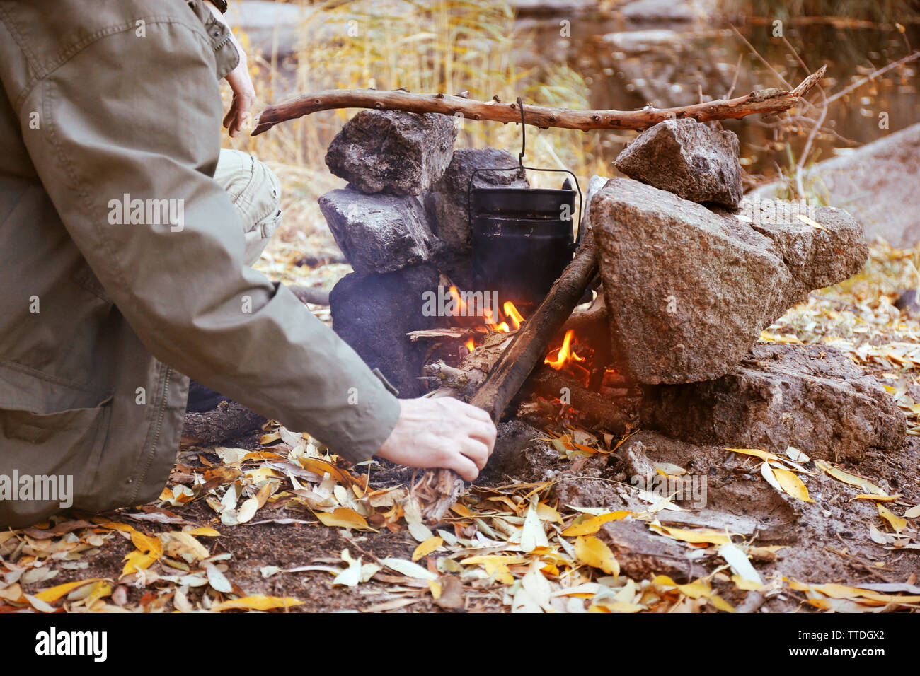 Man making campfire in mountains hi-res stock photography and images ...