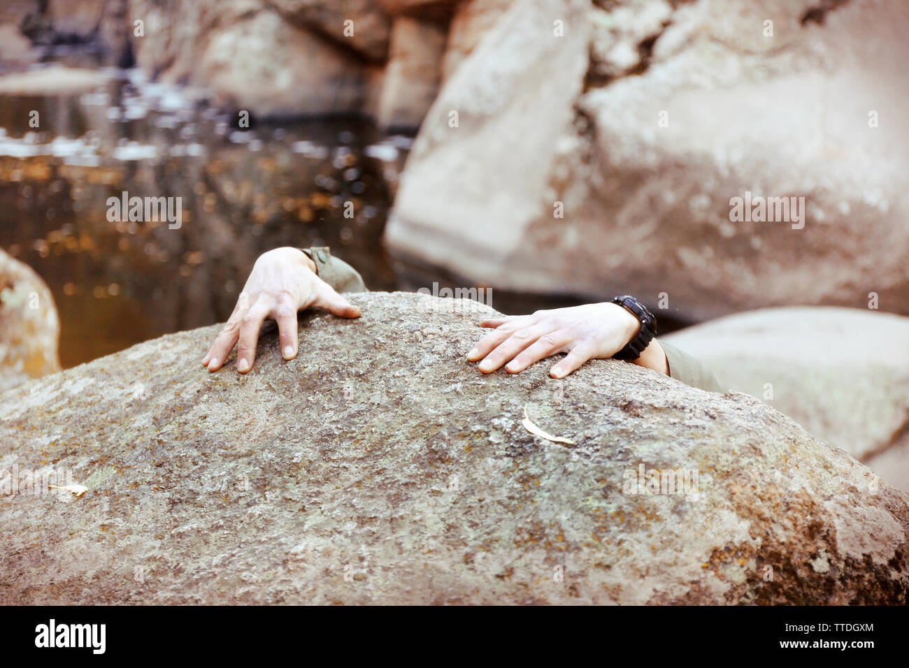 Man trying to climb the rock Stock Photo - Alamy