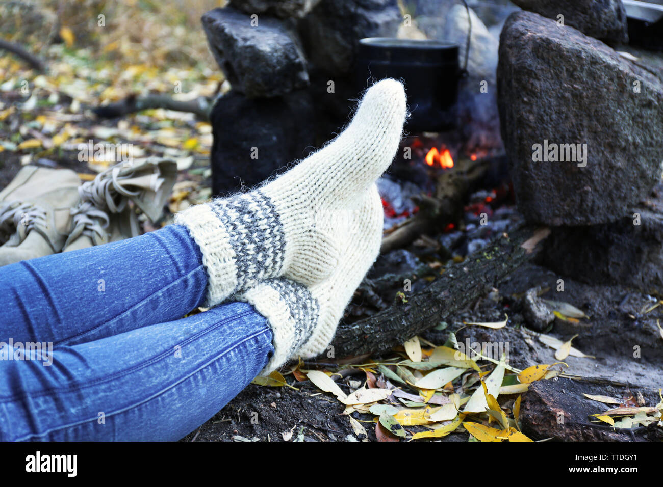 Female legs beside the fire Stock Photo - Alamy