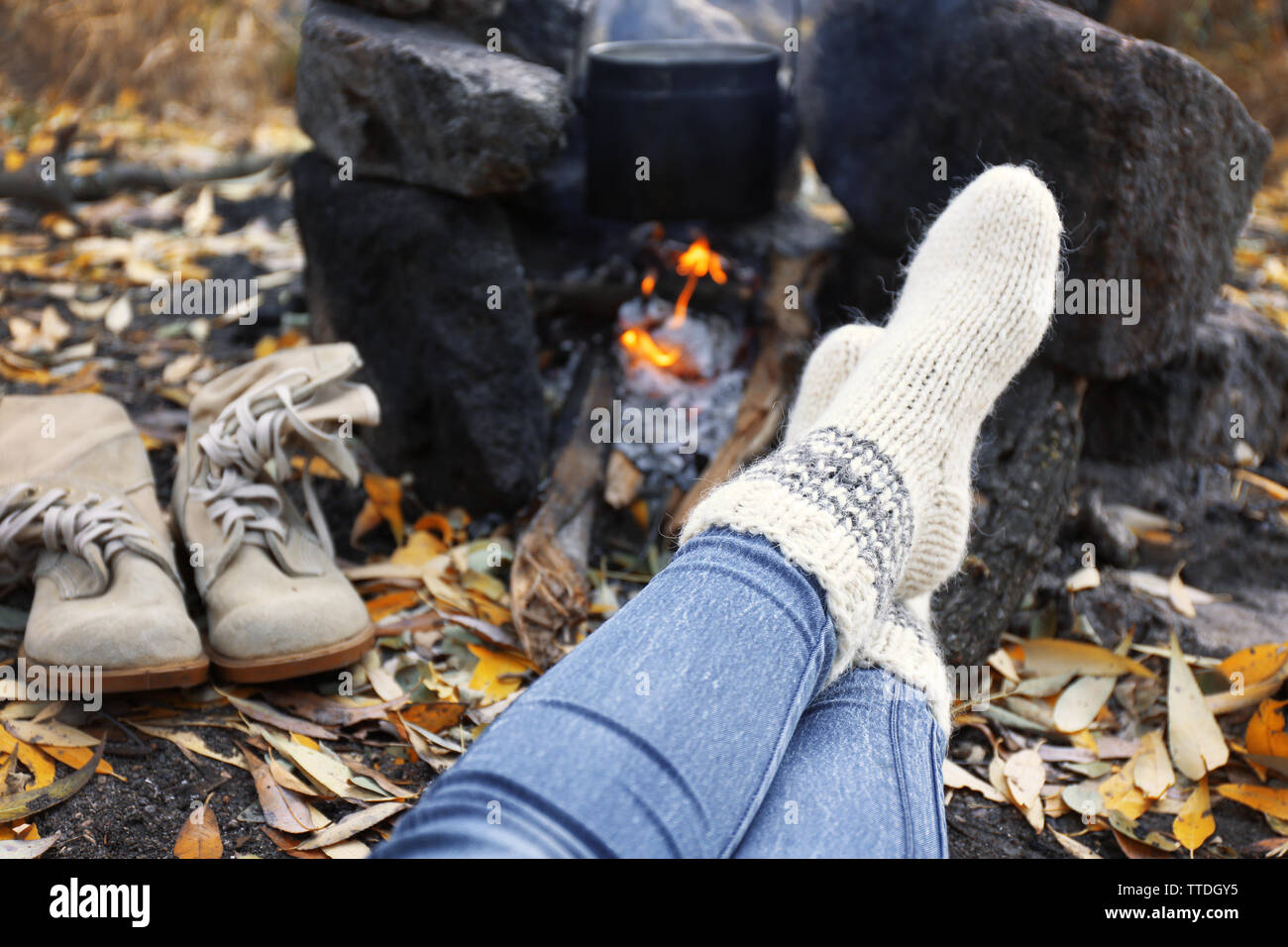 Female legs beside the fire Stock Photo - Alamy