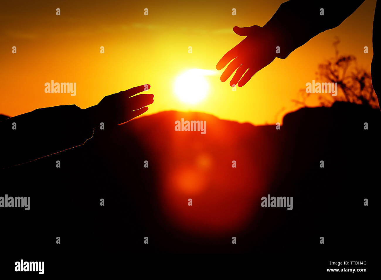 Man giving hand a woman to help her to climb the mountain Stock Photo ...