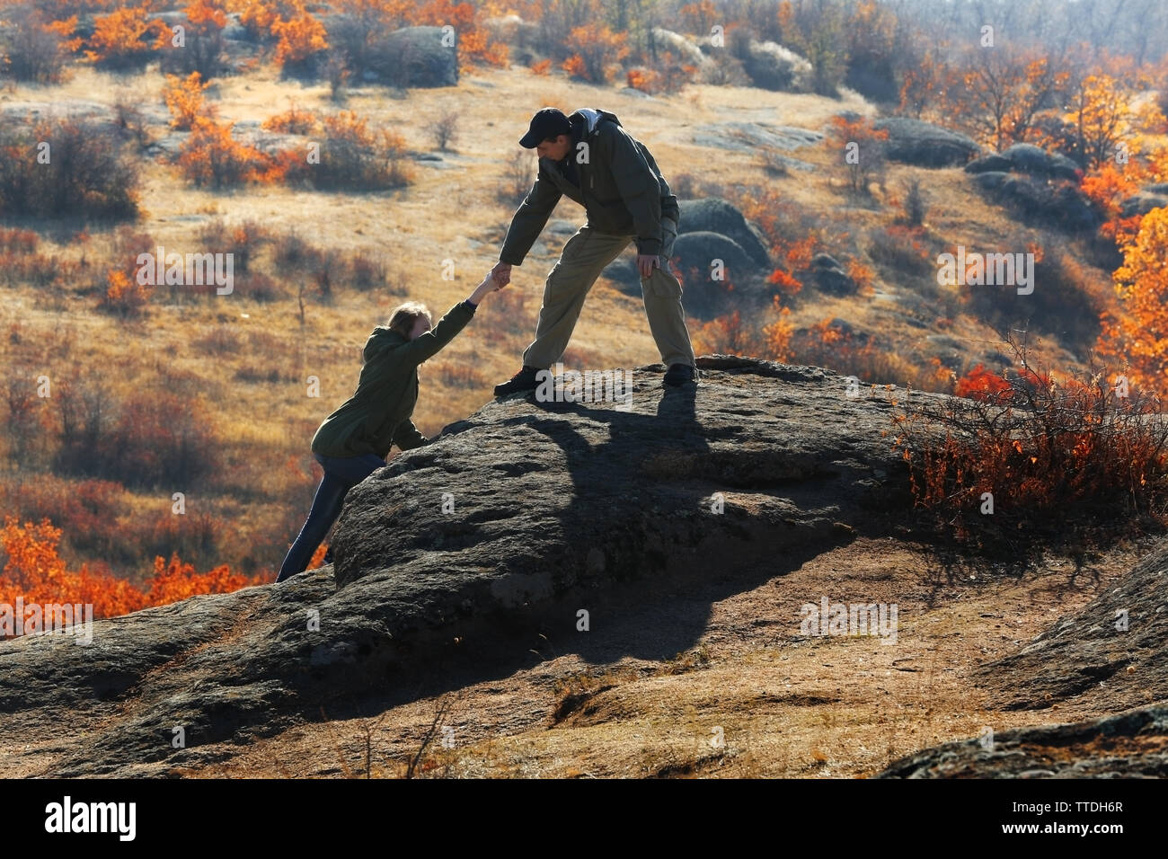 Man and woman climbing the mountain Stock Photo - Alamy