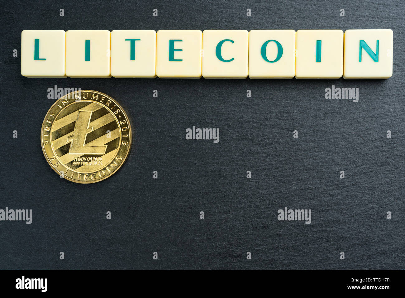 Physical Litecoin gold coin with text made out of letter tiles ...