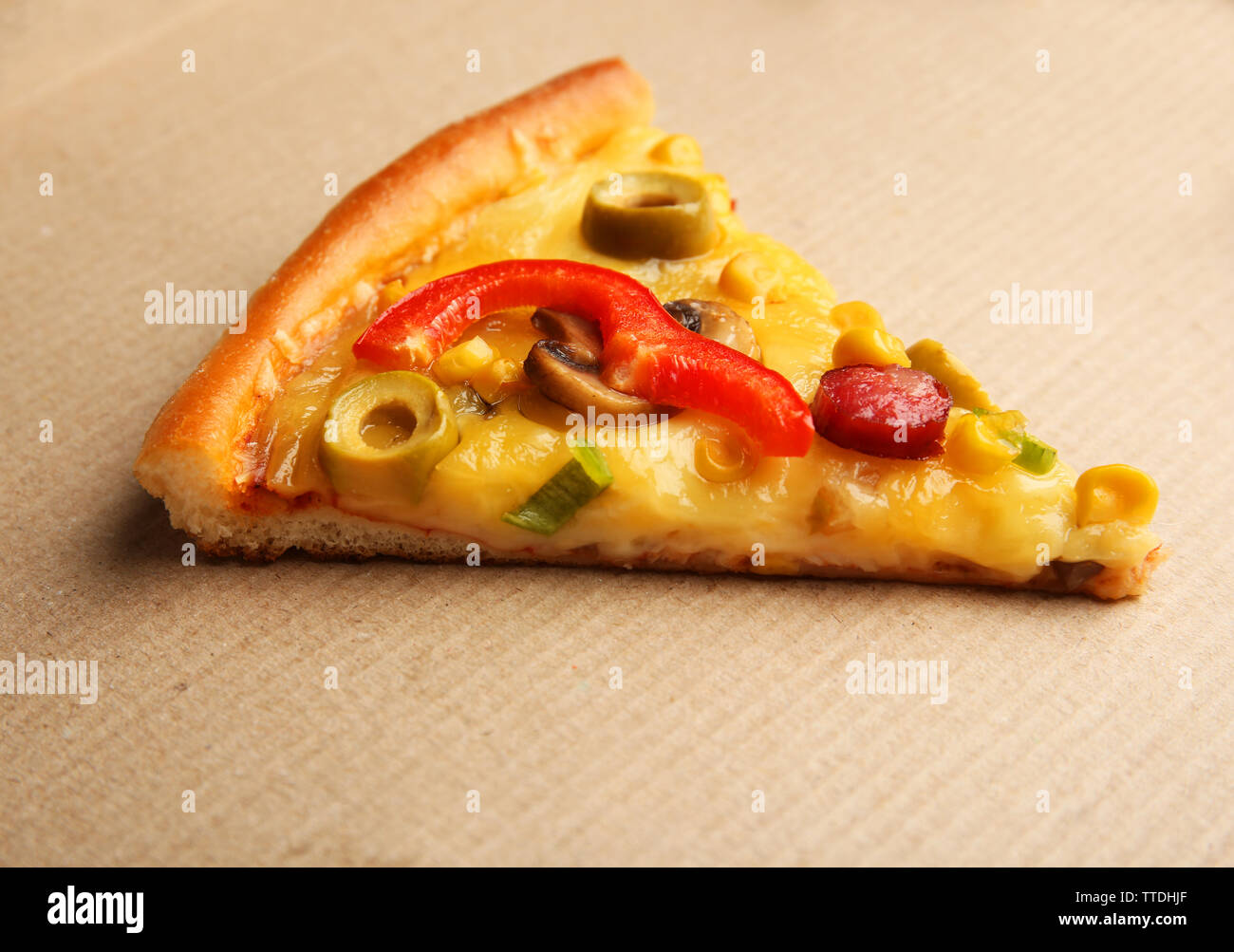 Slice of delicious pizza on cardboard Stock Photo - Alamy