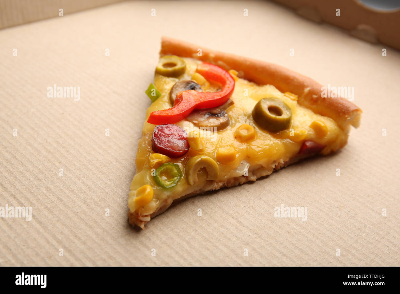 Slice of delicious pizza on cardboard Stock Photo - Alamy
