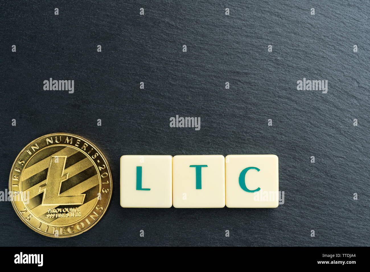 Physical Litecoin gold coin with text made out of letter tiles ...