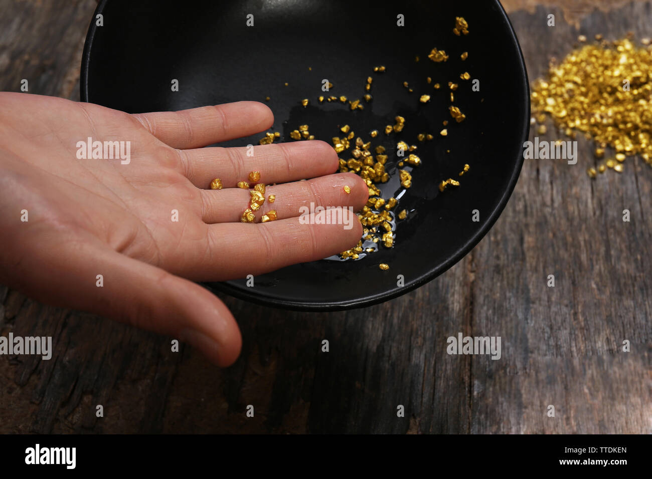 A hand holding gold nugget grains, close-up Stock Photo - Alamy