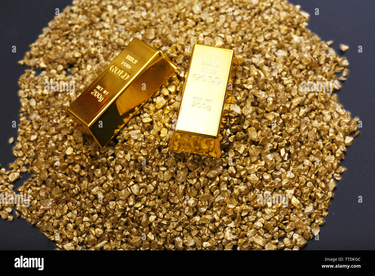 Gold bars on nugget grains background, close-up Stock Photo - Alamy
