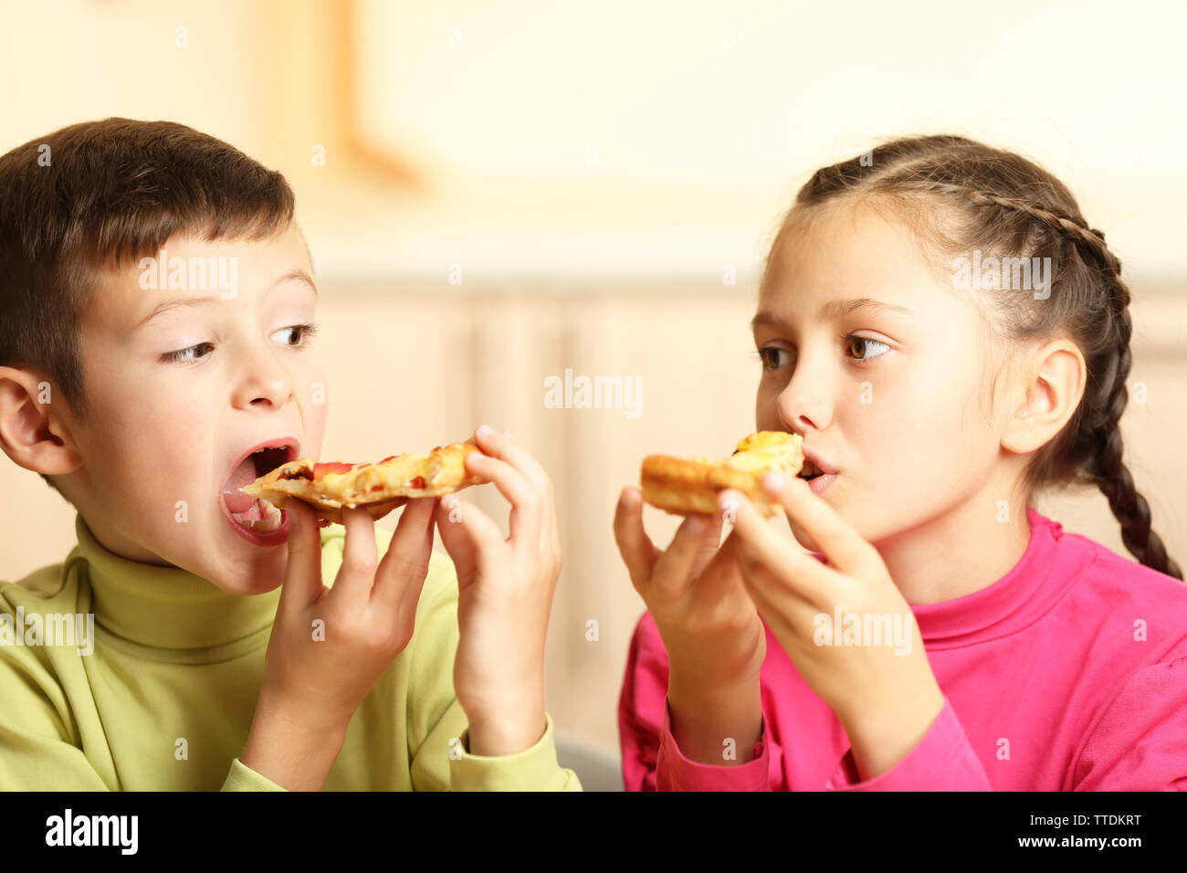 Children eating pizza at home Stock Photo - Alamy