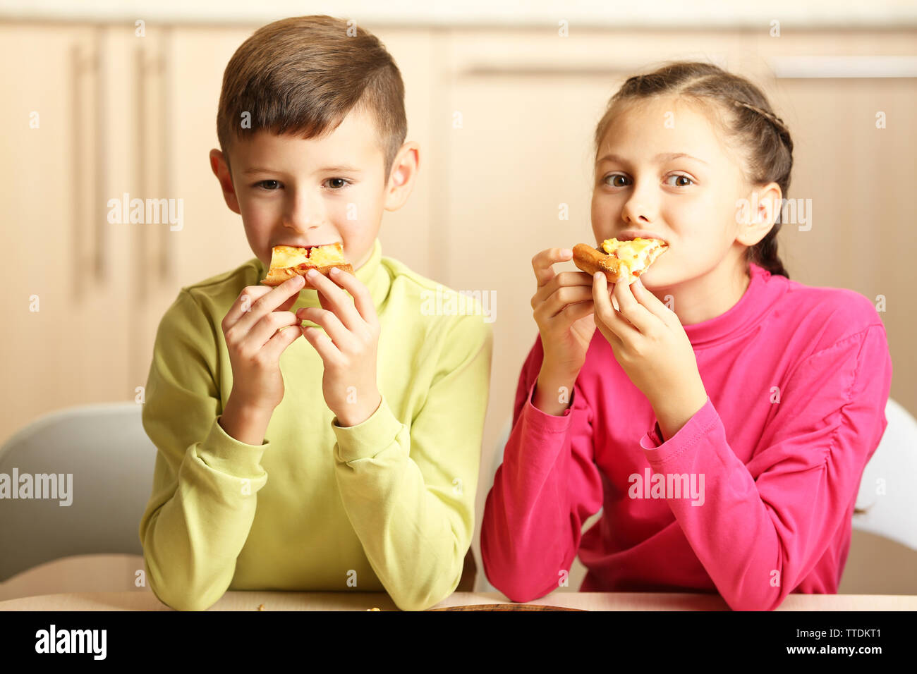 Children eating pizza at home Stock Photo - Alamy