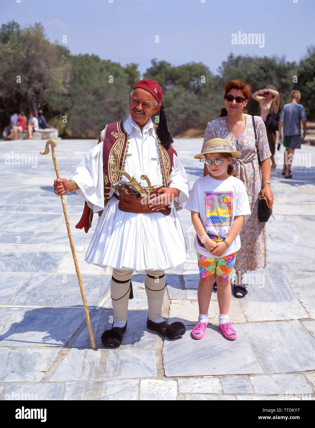 Man in traditional Greek dress with tourists, Plaka, Athens (Athina ...