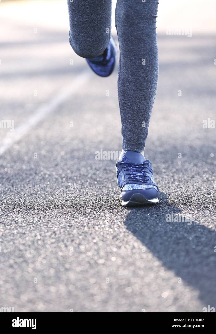 Sports woman legs in running movement Stock Photo - Alamy