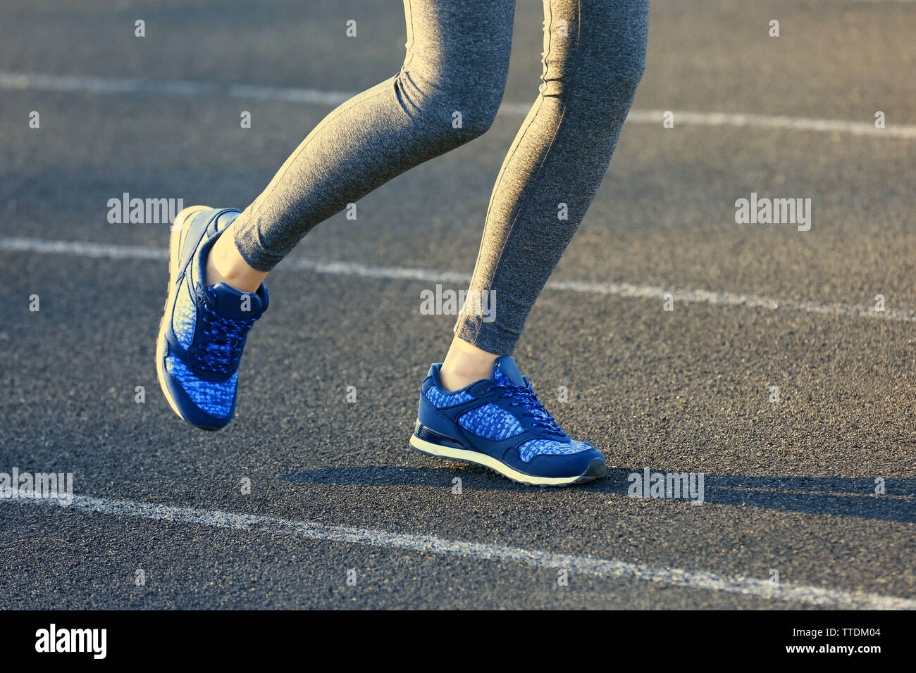 Sports woman legs in running movement Stock Photo - Alamy