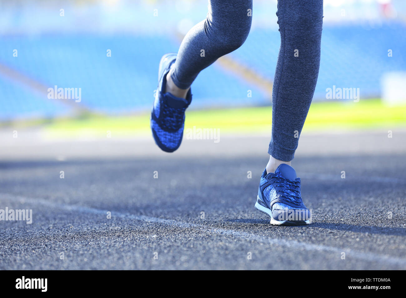 Sports woman legs in running movement Stock Photo - Alamy