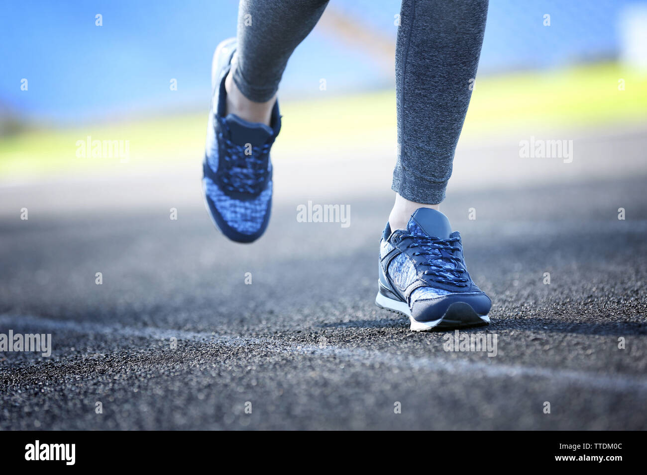 Sports woman legs in running movement Stock Photo - Alamy