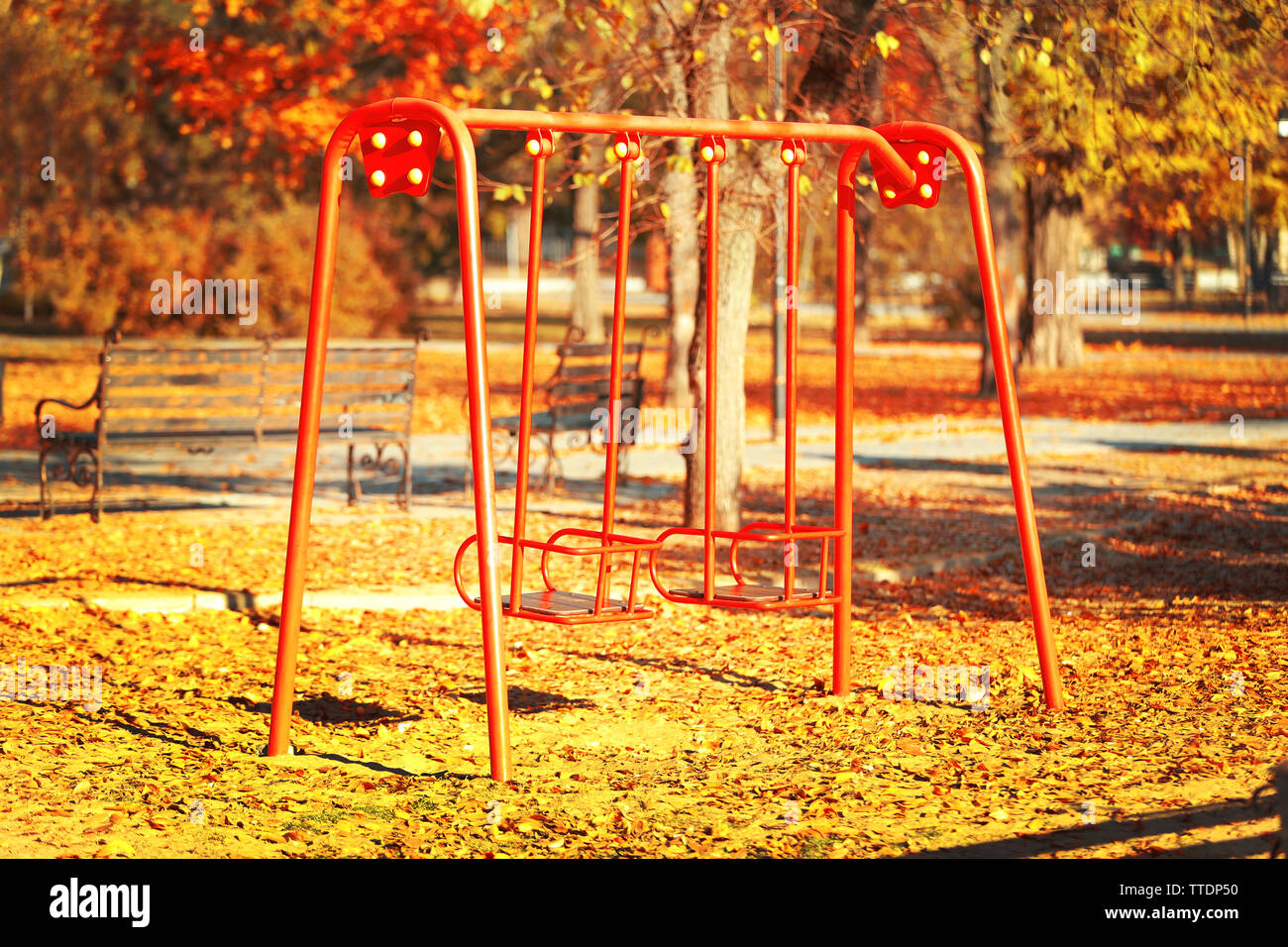 Empty chain swings on playground in city park Stock Photo - Alamy