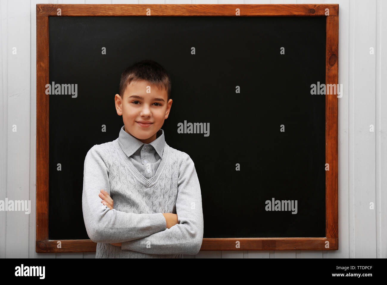 Young cute schoolboy posing at the blackboard Stock Photo - Alamy