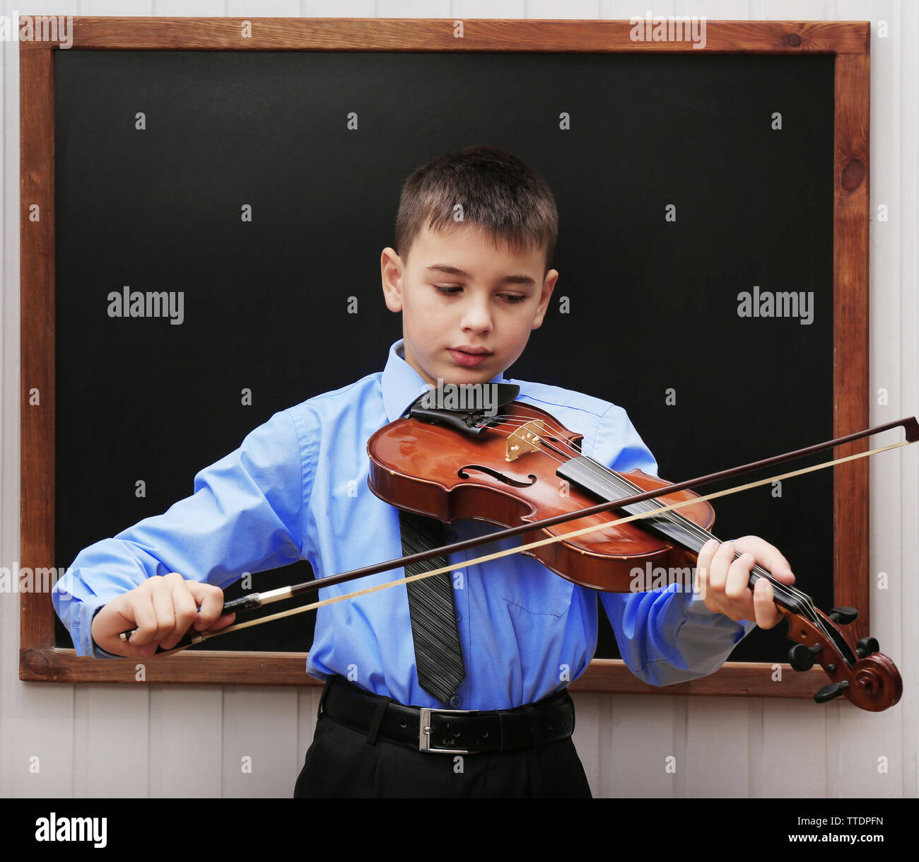 Young cute schoolboy playing the violin at the blackboard Stock Photo ...