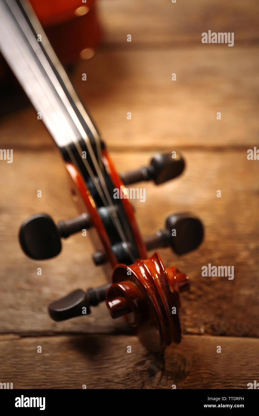 Violin neck on wooden background Stock Photo - Alamy