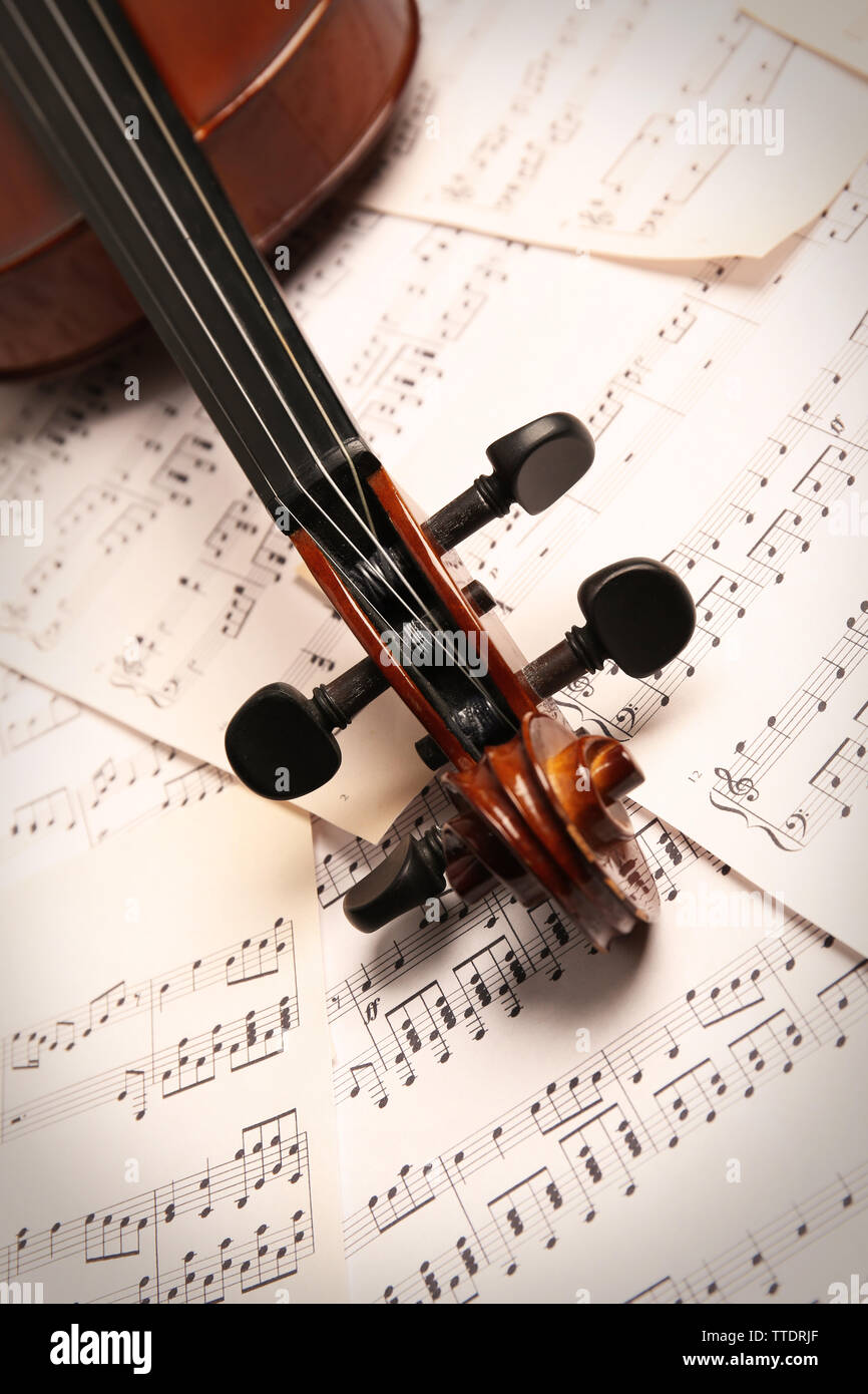 Violin neck on music papers background Stock Photo - Alamy