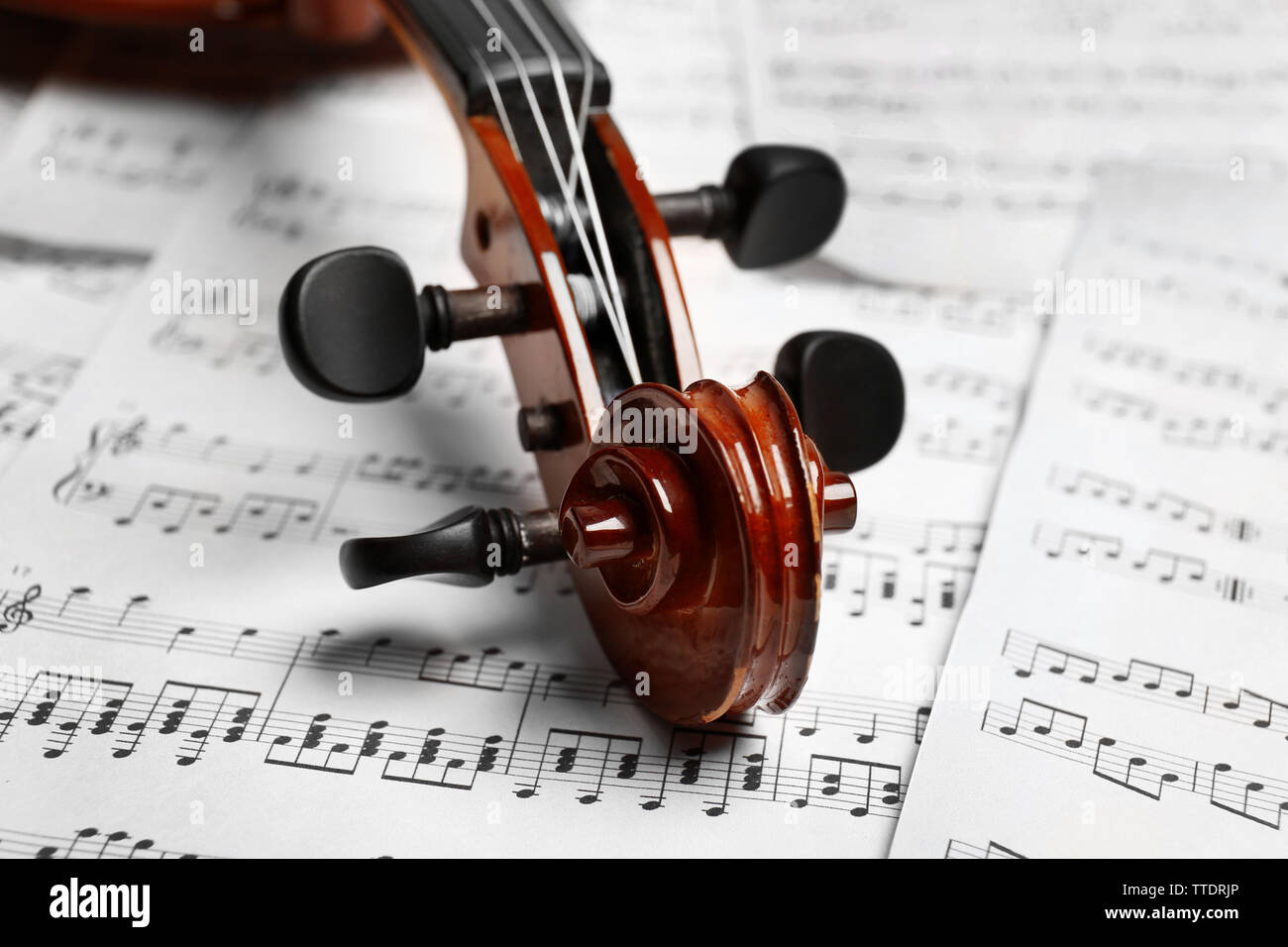 Violin neck on music papers background Stock Photo - Alamy