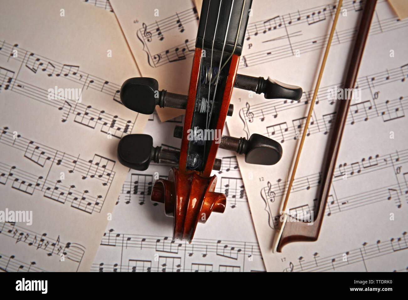 Violin neck on music papers background Stock Photo - Alamy