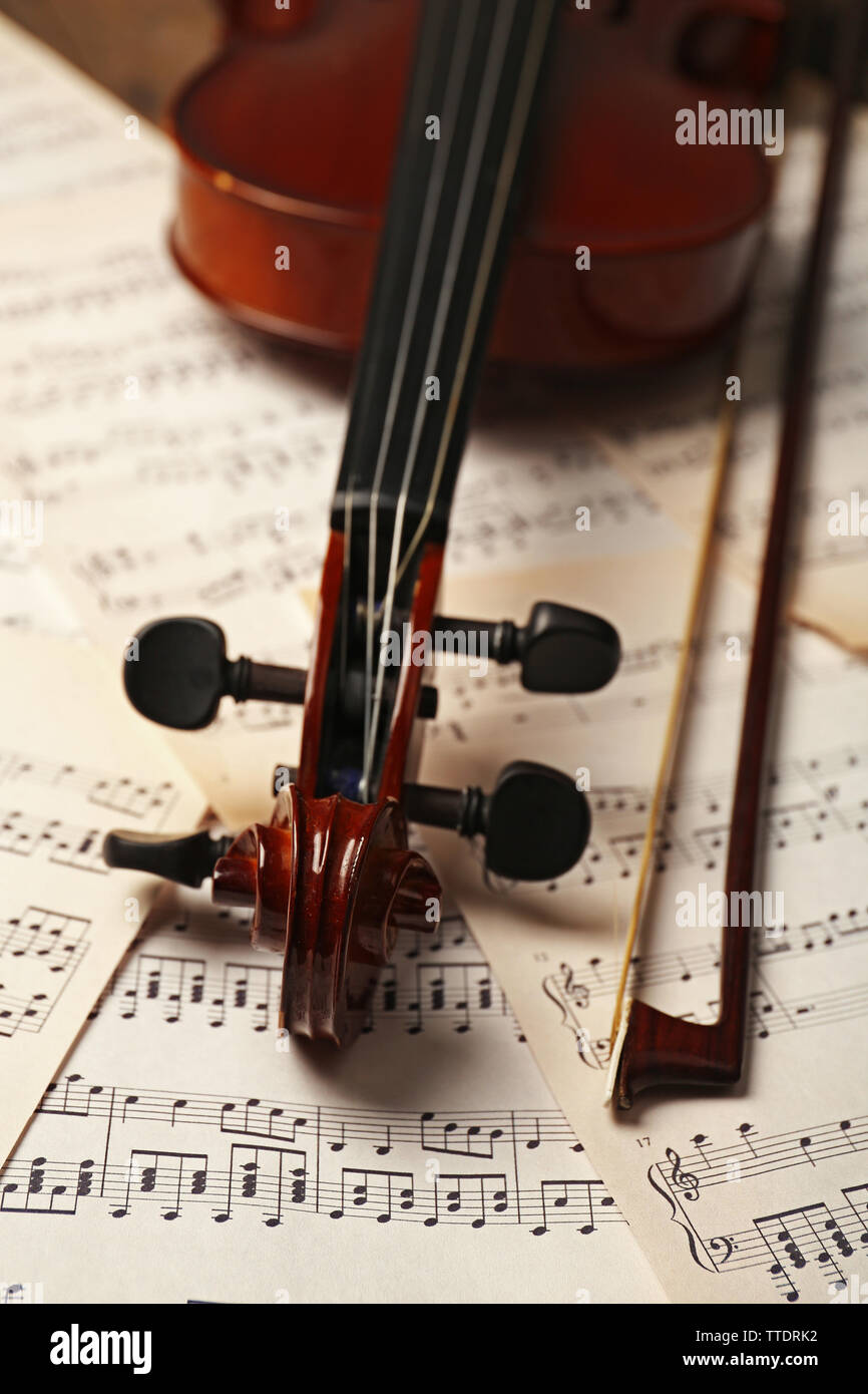 Violin neck on music papers background Stock Photo - Alamy