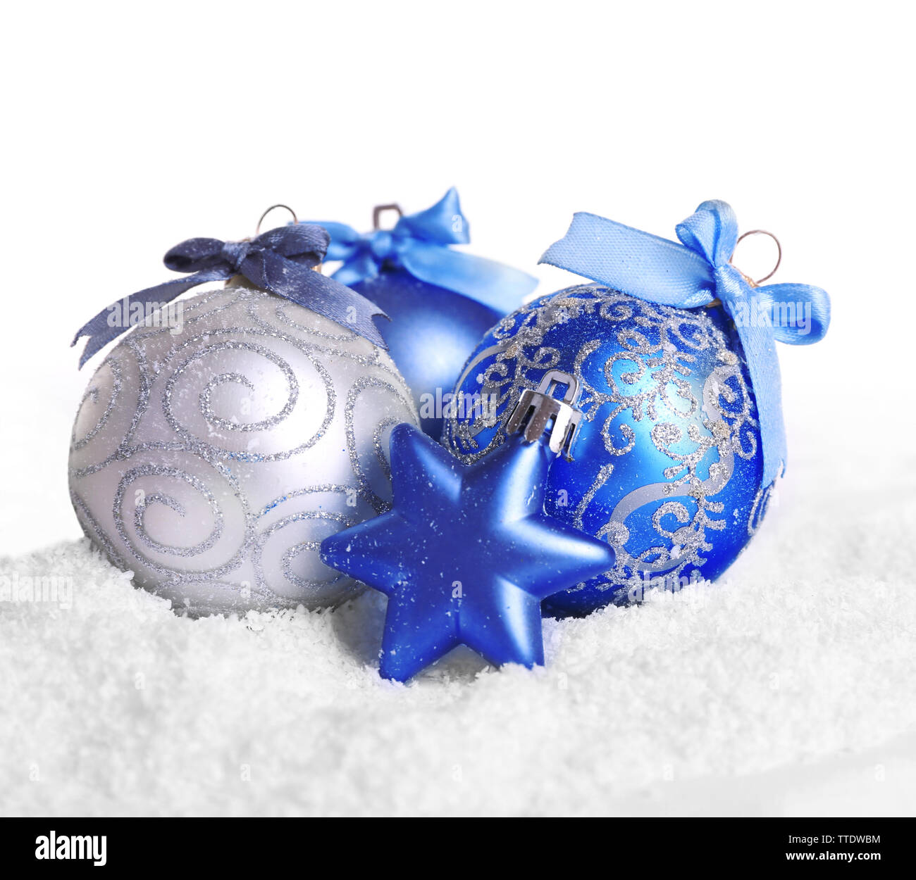 Christmas balls on snow with white background Stock Photo - Alamy
