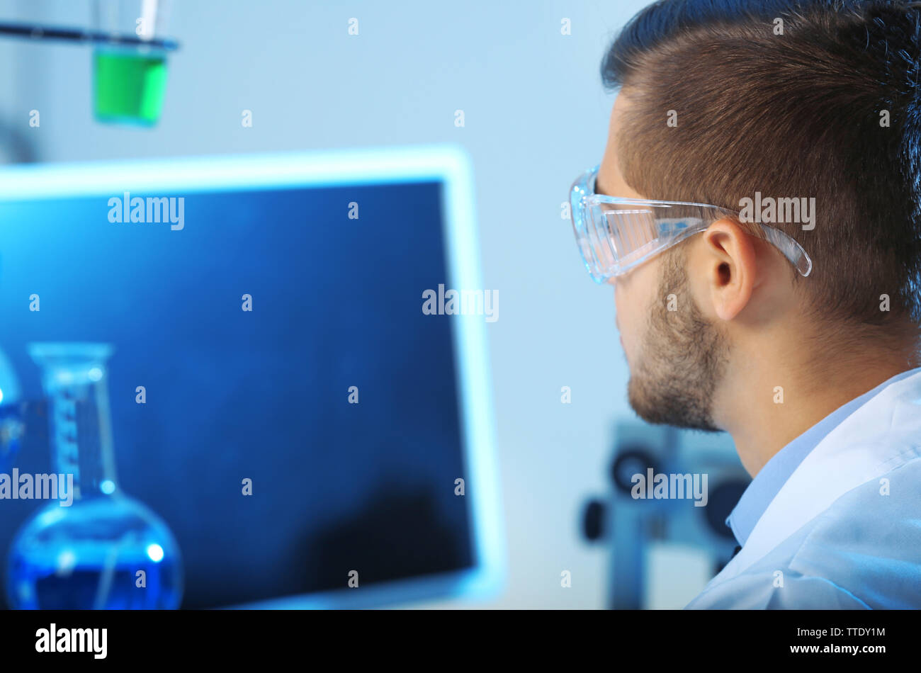 Man in laboratory checking test tubes Stock Photo - Alamy