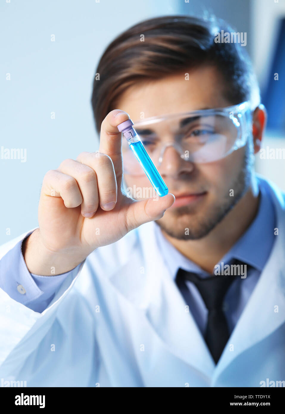Man in laboratory checking test tubes Stock Photo - Alamy