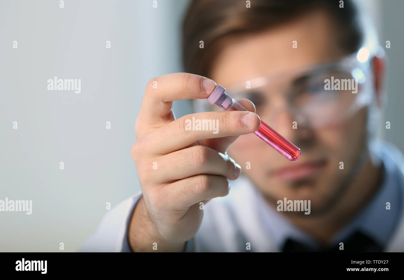 Man in laboratory checking test tubes Stock Photo - Alamy