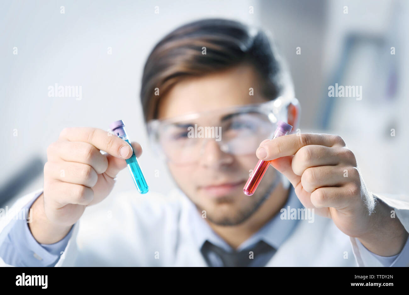 Man in laboratory checking test tubes Stock Photo - Alamy