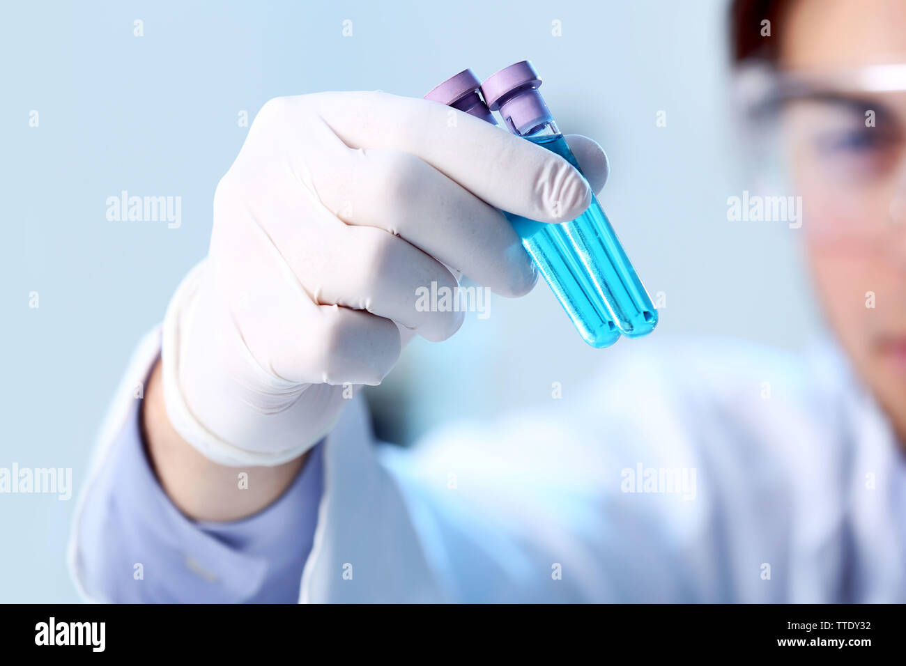 Man in laboratory checking test tubes Stock Photo - Alamy