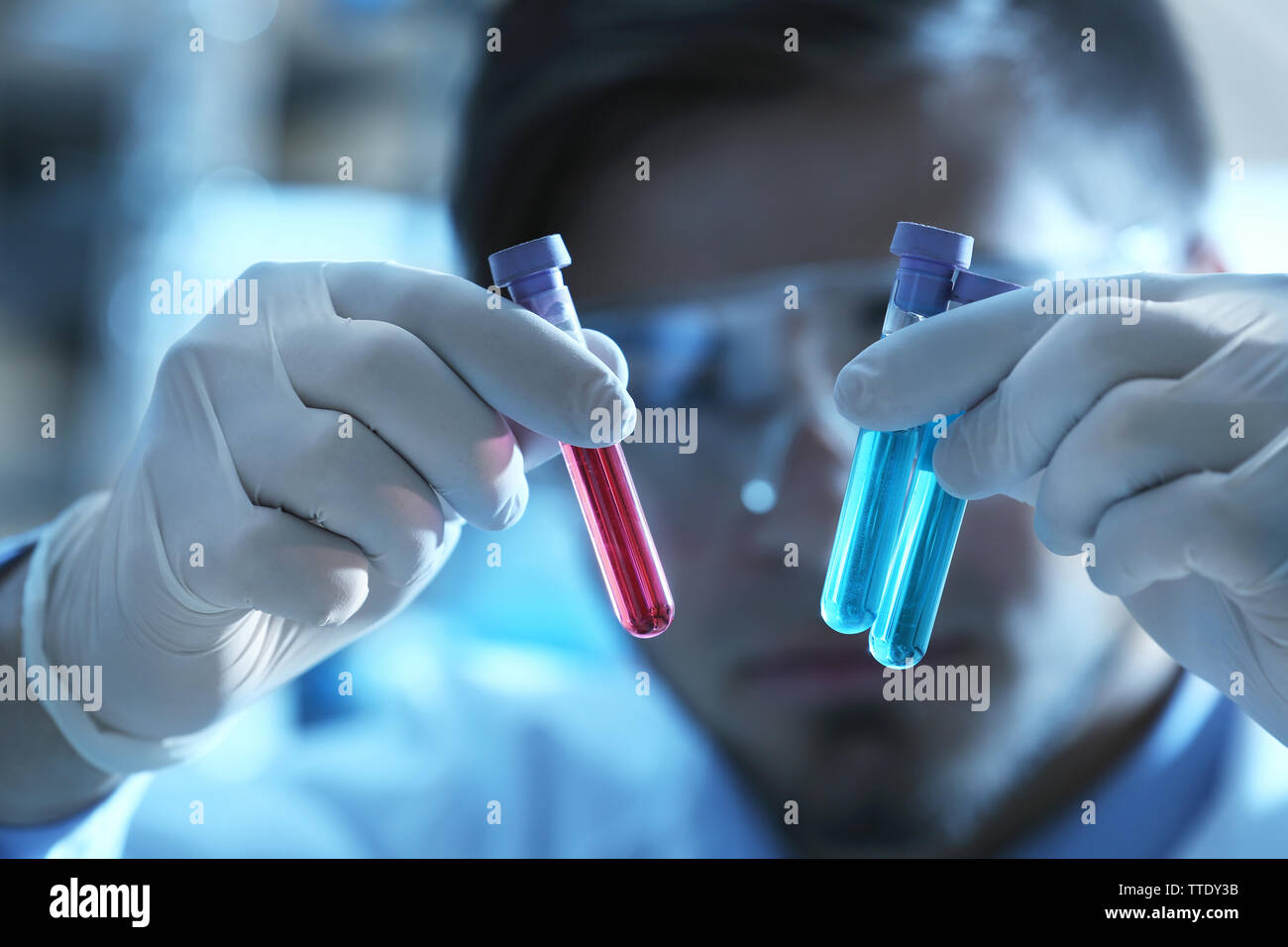 Man in laboratory checking test tubes Stock Photo - Alamy
