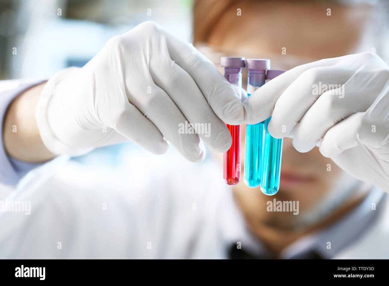 Man in laboratory checking test tubes Stock Photo - Alamy