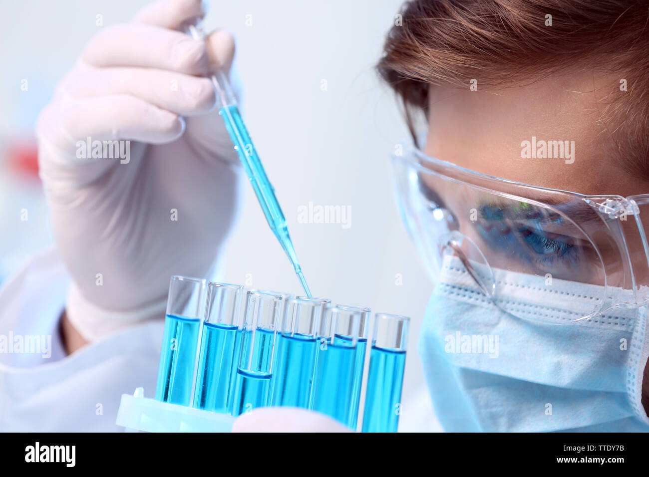 Man in laboratory checking test tubes Stock Photo - Alamy