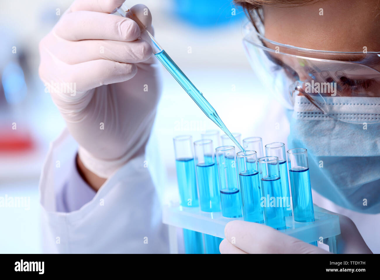 Man in laboratory checking test tubes Stock Photo - Alamy