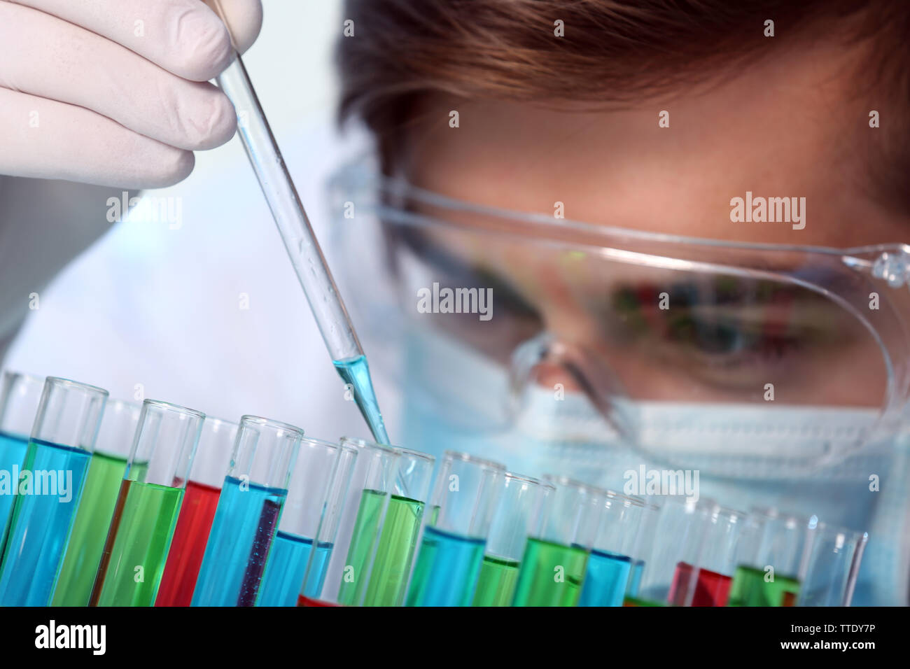Man in laboratory checking test tubes Stock Photo - Alamy