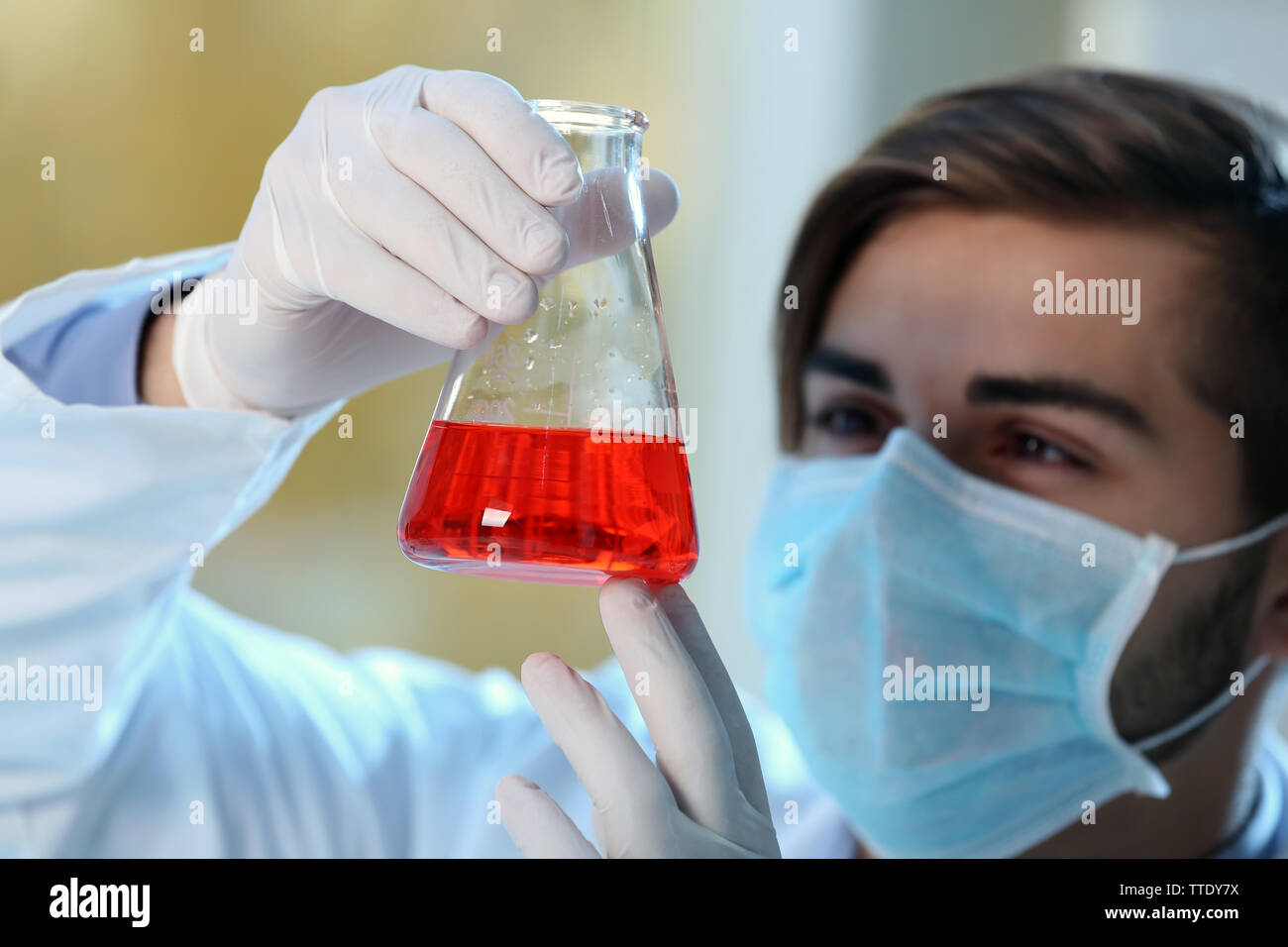 Man in laboratory checking test tubes Stock Photo - Alamy