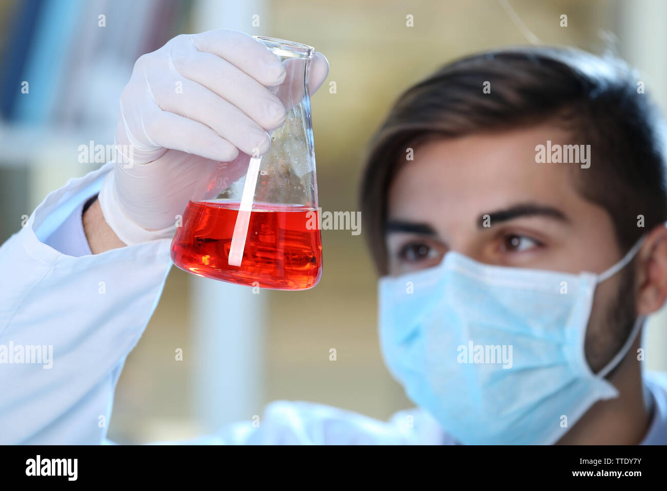 Man in laboratory checking test tubes Stock Photo - Alamy